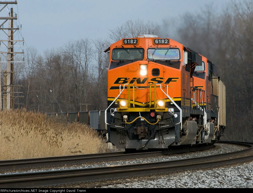 Westbound CSX E942 is led by bnsf 6182 on track number one at QD CP163